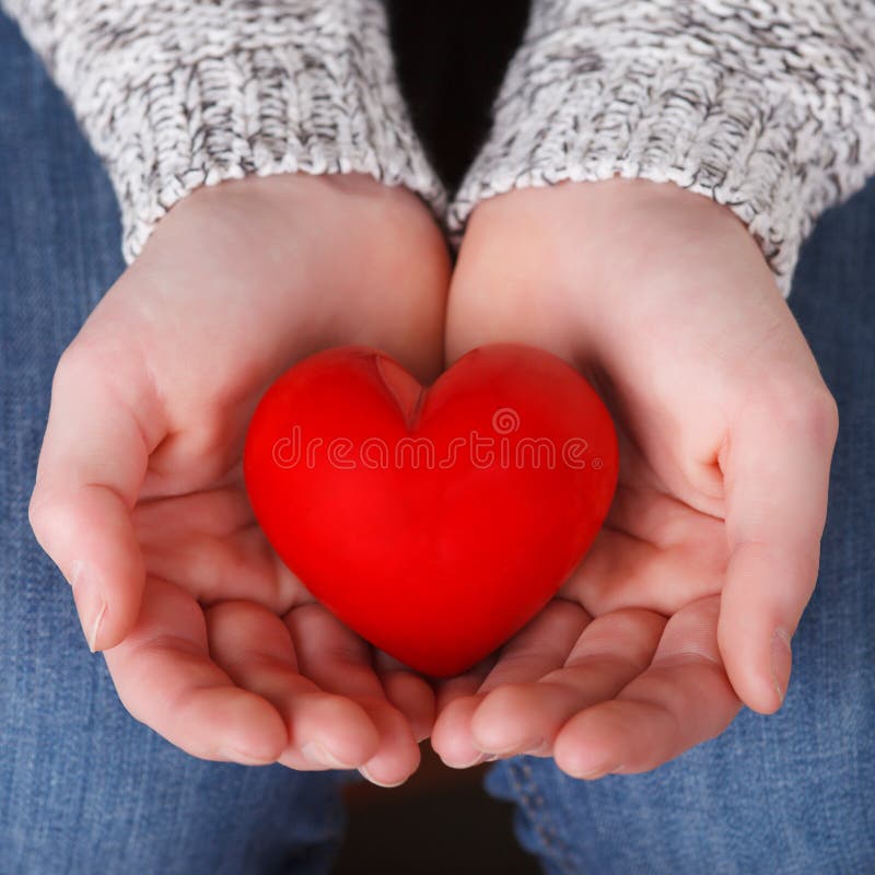 Gentle Womens Hands and a Red Heart Glowing in His Hands. Valentines ...