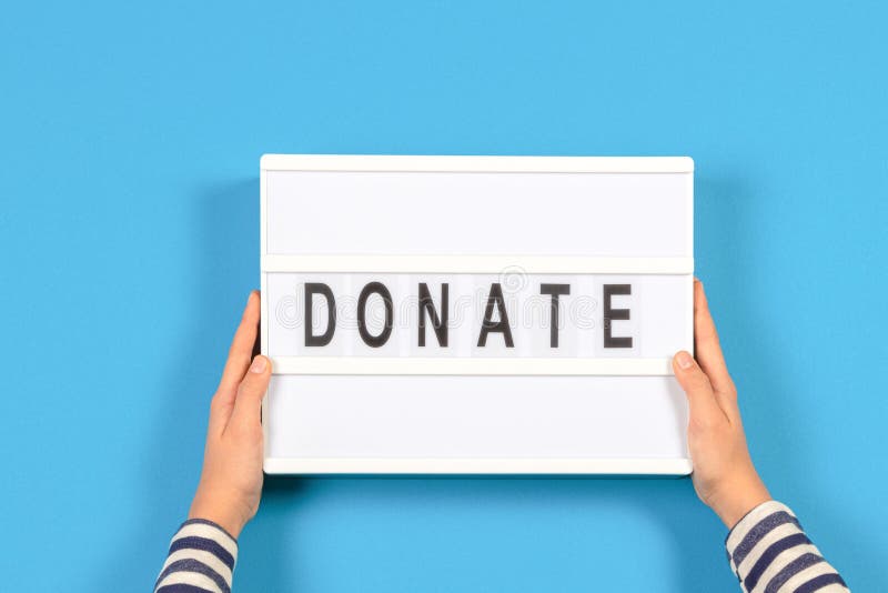 Hands Holding Light Box with Donate Word Text Over Light Blue ...