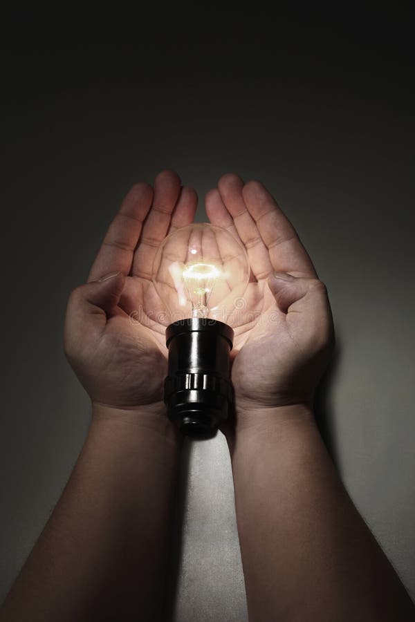 Hands Holding Lit Light Bulb. Conceptual Image Stock Image - Image of ...