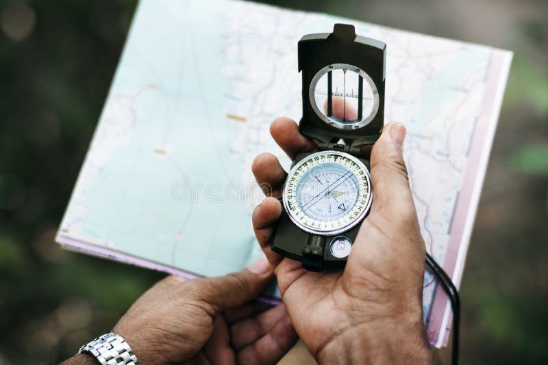 Hands Holding Map and Compass Stock Image - Image of tree, casual ...