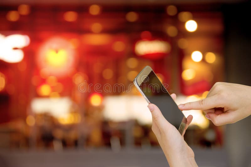 Hands Holding Mobile Smartphone with Restaurant Concept Blurred ...