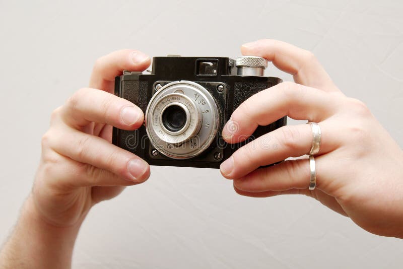 Hands Holding An Old Camera Stock Photo - Image of white, film: 4118786