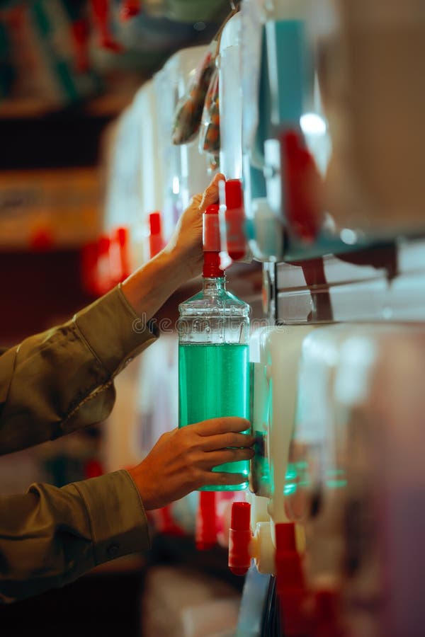 Hands Holding a Plastic Bottle at Detergent Refilling Station Stock ...