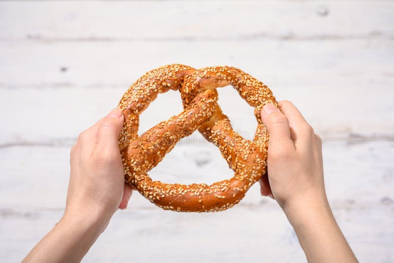 Hands Holding a Pretzel stock image. Image of salted - 171378409