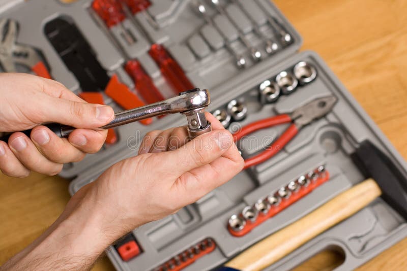 Hands Holding Ratchet and Head Over Toolbox Stock Photo - Image of ...