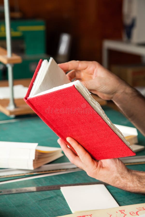 Hands Holding Red Cover Book at Table Stock Photo - Image of expertise ...