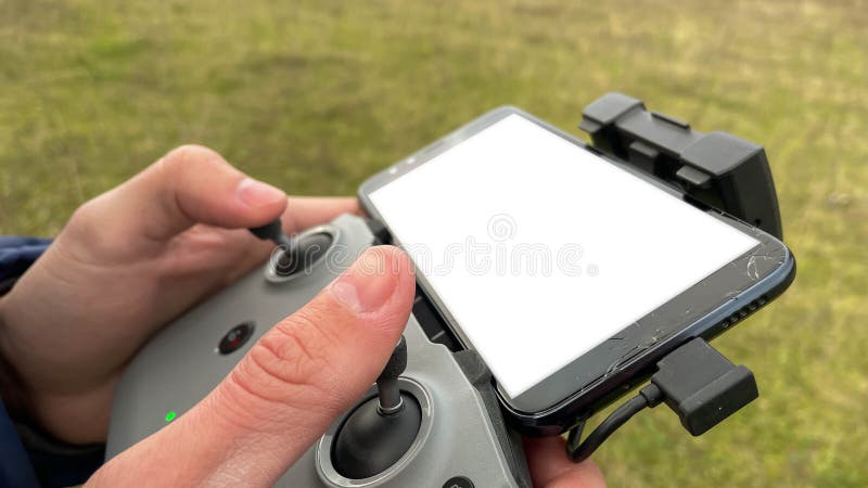 Hands Holding the Remote Control with the Phone from the Drone White ...