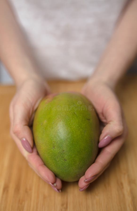 Person holding mango slice stock image. Image of eating - 133952025