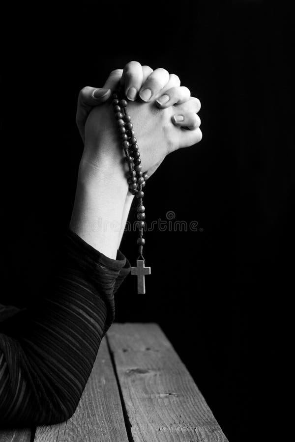 Hands Holding Rosary with a Cross and Folded in Prayer Stock Photo ...