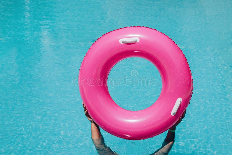 Hands Holding Rubber Pink Swimming Ring Above the Water in Swimming ...