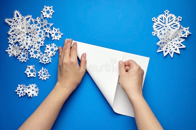 Hands Holding a Sheet of Paper for Making Snowflakes Stock Photo ...