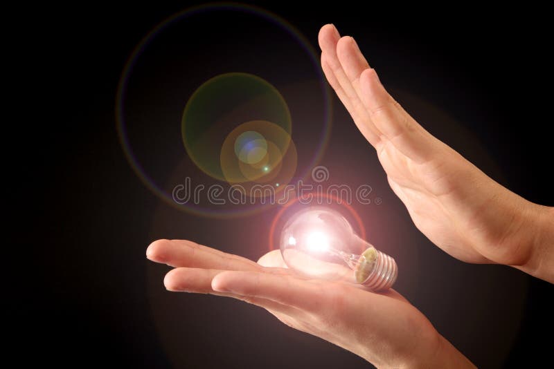 Hands holding shining lamp stock image. Image of isolated - 5180057