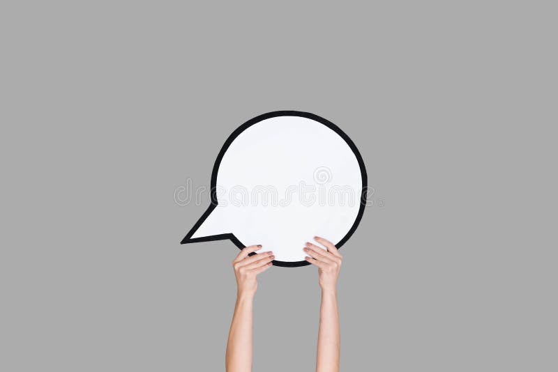 Hands Holding the Sign of Comment on Grey Studio Background Stock Photo ...