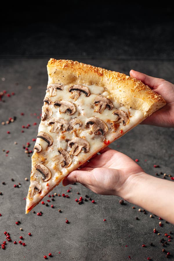 Holding a Slice of Large Mushroom Pizza Stock Photo - Image of vertical ...