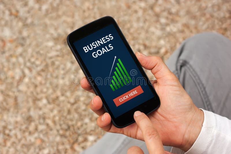 Hands Holding Smart Phone with Business Goals Concept on Screen Stock ...