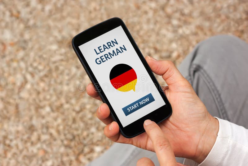 Hands Holding Smart Phone with Learn German Concept on Screen Stock ...