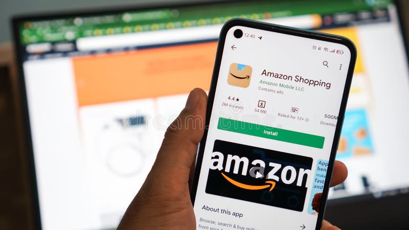 Hands are Holding Smartphones. Open the Amazon Application with the ...