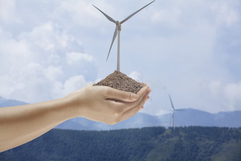 Hands Holding Soil with a Wind Turbine Growing Out from the Middle ...