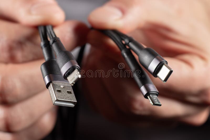 Hands Holding Universal Adapter Cable from USB Connector To Micro USB ...