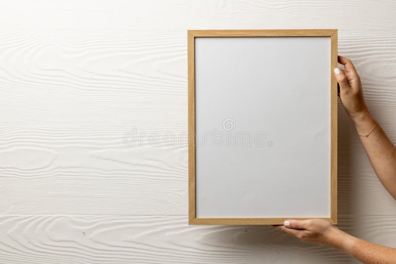 Hands Holding Wood Empty Frame with Copy Space Against White Wall Stock ...