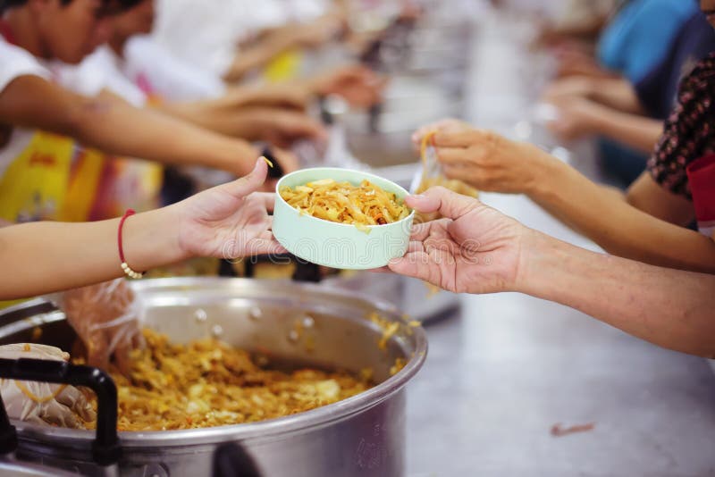 The Hands Of The Hungry Are Asking For Food From The Donor Editorial ...