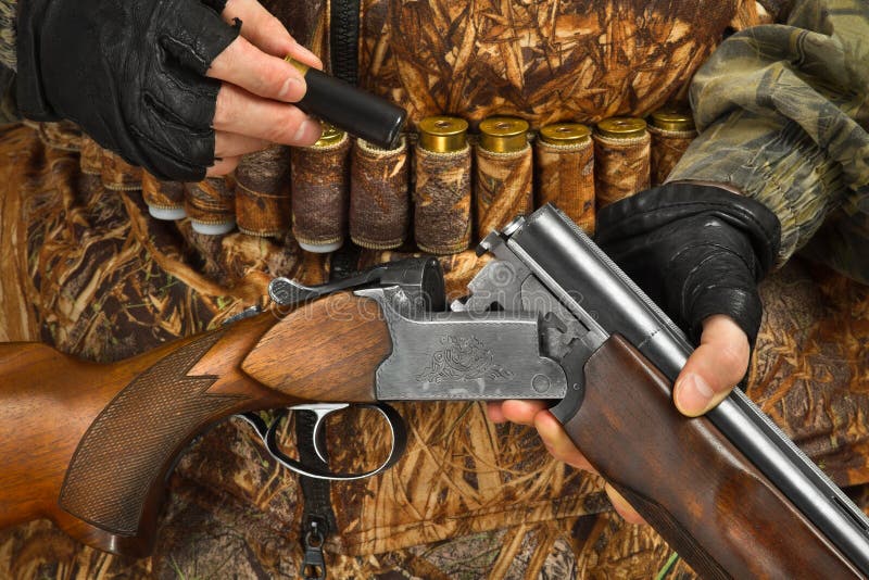 Hands loading shotgun stock photo. Image of adult, human - 137794616