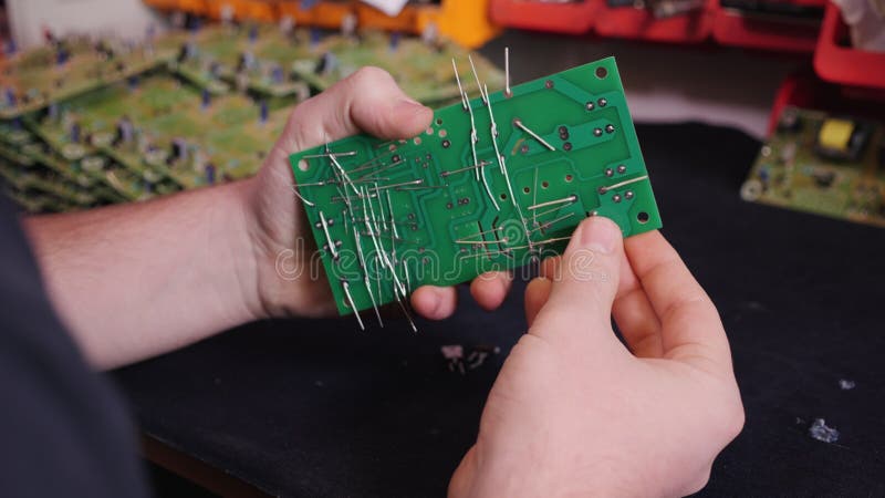 Hands Inserting Electronic Component into Printed Circuit Board - Close ...
