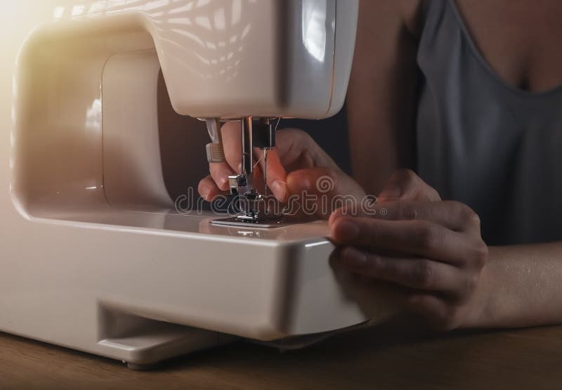 Hands Inserting Thread through Needle Hole in Sewing Machine, Details ...