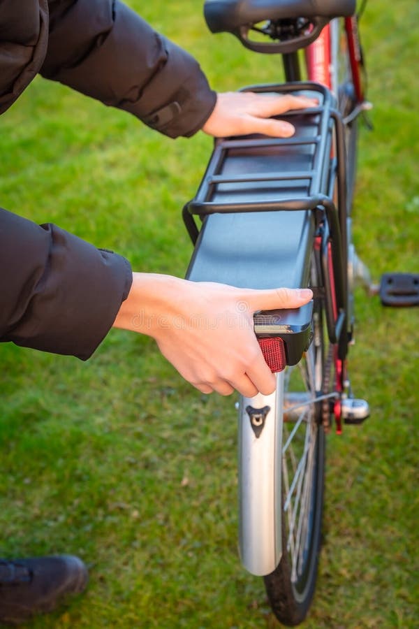Hands Installing and Inserting Battery on a Frame on Electric Bike ...