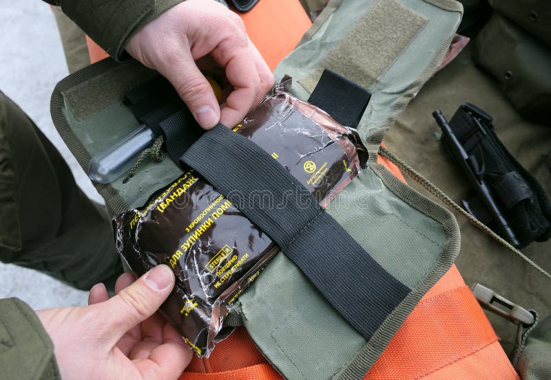 Hands of Instructing Officer Holding First-aid Kit Pack Showing Its ...