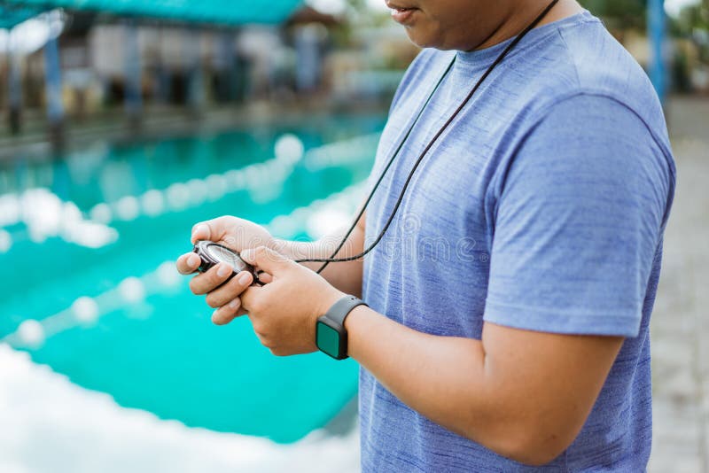 A Swimming Coach with a Stopwatch on His Neck Standing on a Watch Stock ...