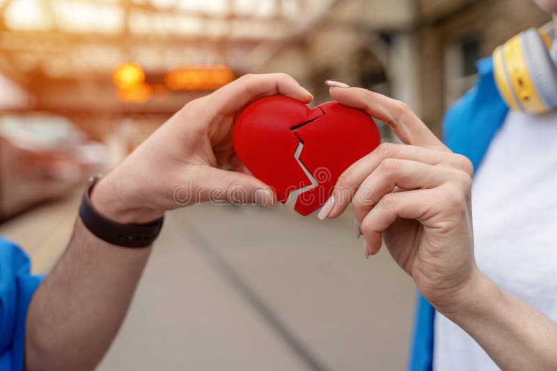 Hands Joining and Holding Red Broken Heart. Getting Together after a ...