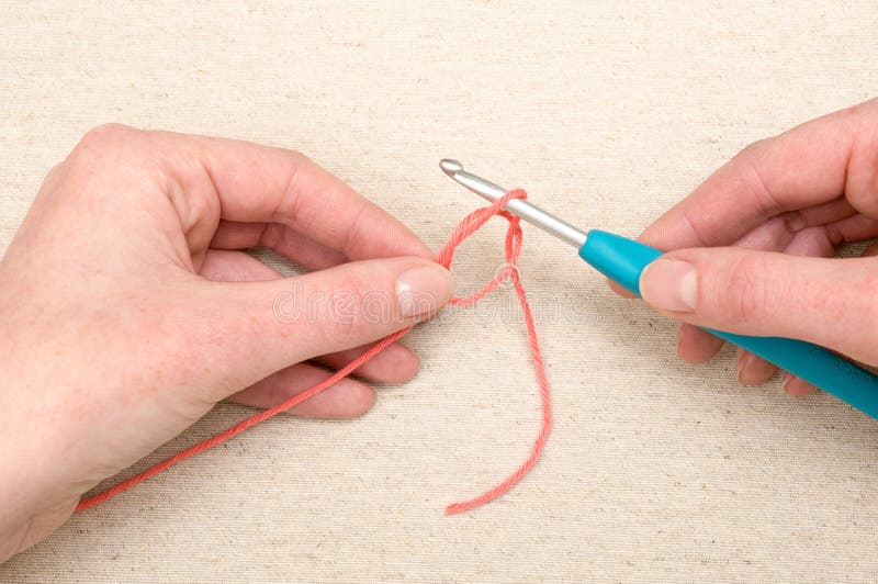 Hands Knitting a Strand of Orange Yarn with Crochet Hook Stock Photo ...