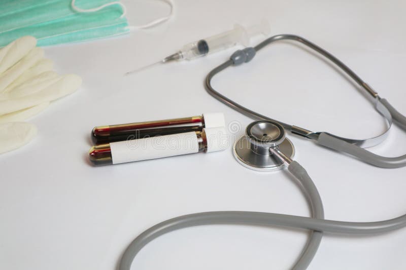 Hands of a Lab Technician with a Tube of Blood Sample and a Rack with ...