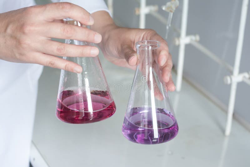 In the Hands of the Laboratory Assistant are Flasks with a Substance of ...