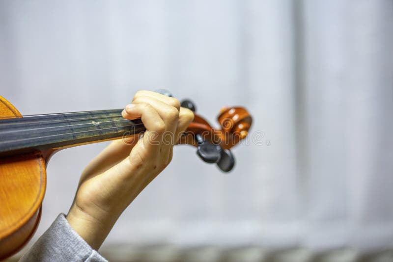 Hands of a Little Violinist while Playing the Violin, Staging the Hands ...