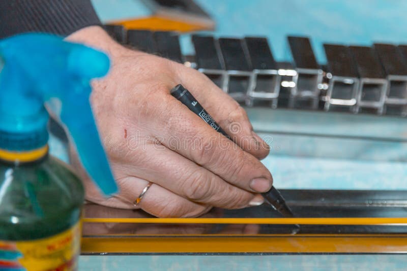 The Hands of a Locksmith Mark Out a Stainless Profile Pipe Stock Photo ...