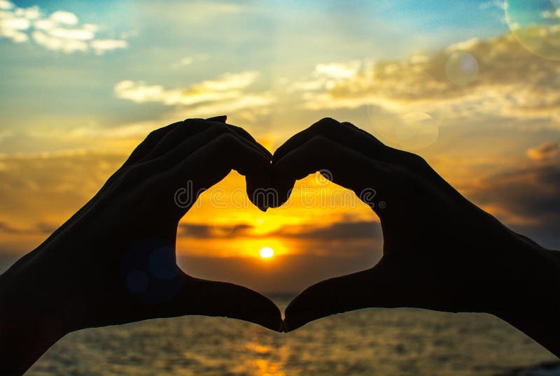 Hands make heart at sunset stock photo. Image of hand - 49211416