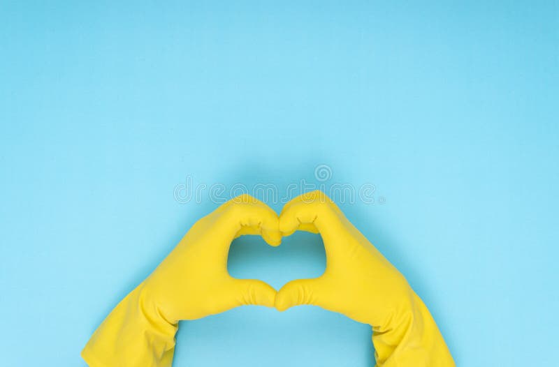 Hands Making Heart Shape with Yellow Cleaning Glove on Blue Background ...