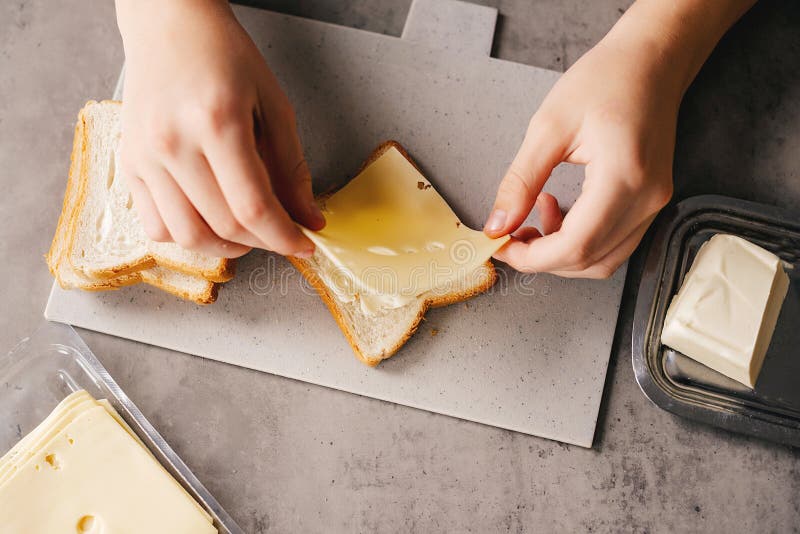 Hands Making Sandwich. Preparing Breakfast, Putting Cheese on Toast ...