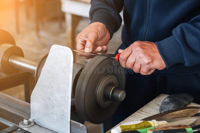 Hands of a Male Sharpener Grinder Sharpening Knife Blade on Sharpening ...
