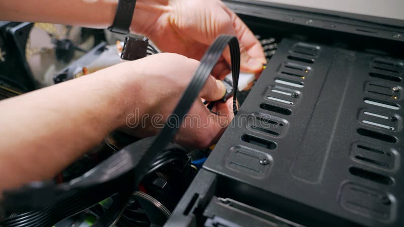 Hands of a Man. Connecting Wires from a Power Supply. Computer Assembly ...