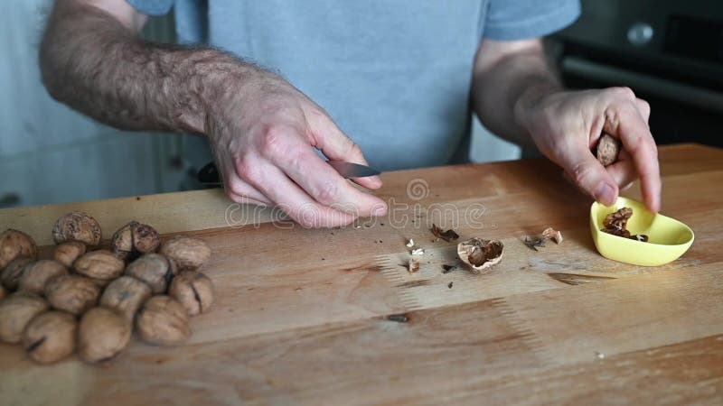 Hands of a Man Cracking Walnuts with a Nutcracker Stock Video - Video ...