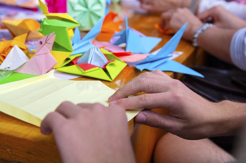 Hands of a Man Creating a Colored Origami Paper Stock Image - Image of ...