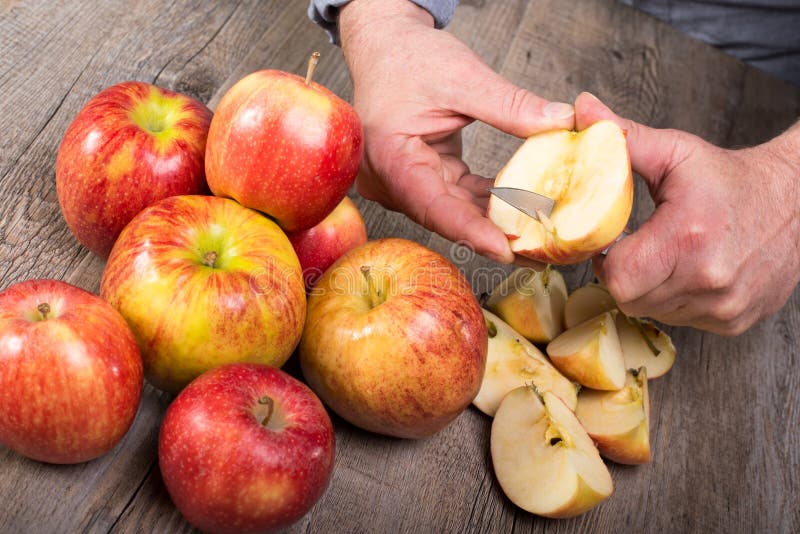 Hands of a Man Cutting an Apple Stock Photo - Image of male, race: 39337186