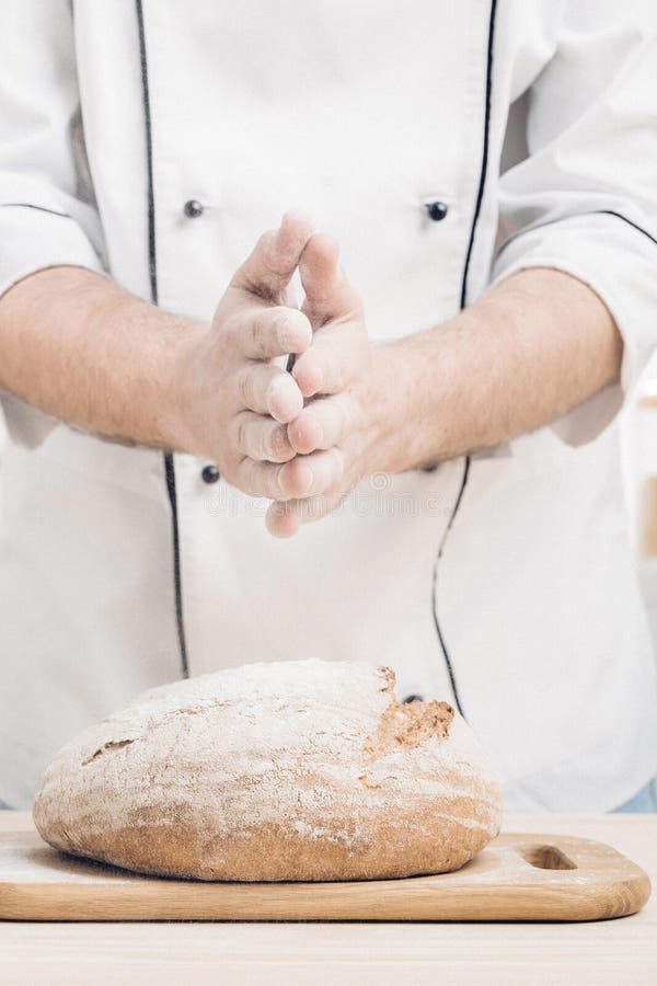 Hands of Man and Fresh Baked Bread on Wooden Table. Soft Light Stock ...