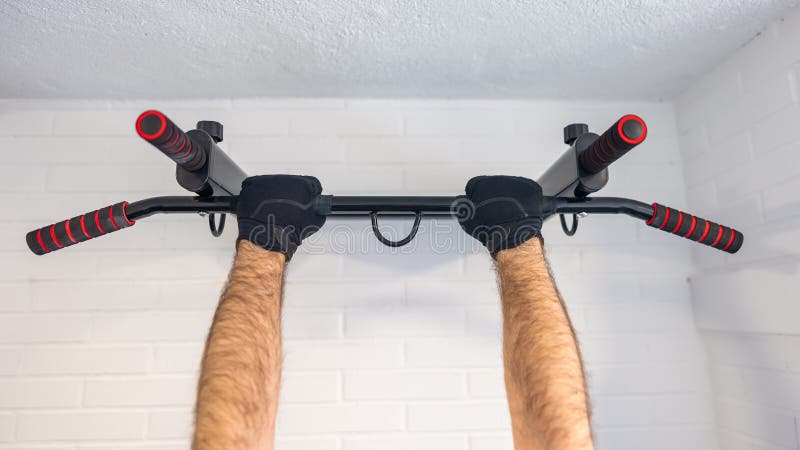 Hands of a Man Holding a Bar Anchored To the Wall To Do Pull-ups and ...