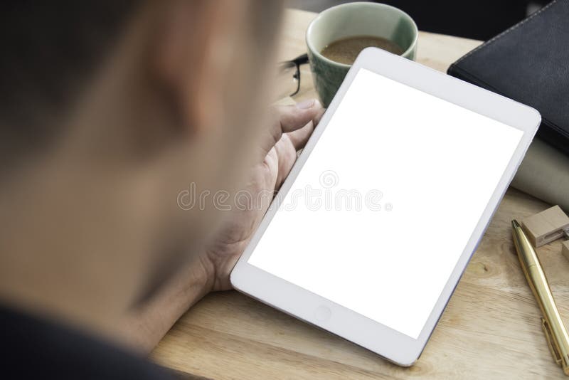 Hands of a Man Holding Blank Tablet Device Over a Wooden Workspace ...