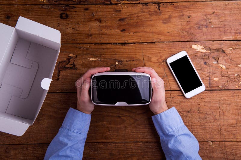 Hands of Man Holding Virtual Reality Goggles, Wooden Table Stock Photo ...