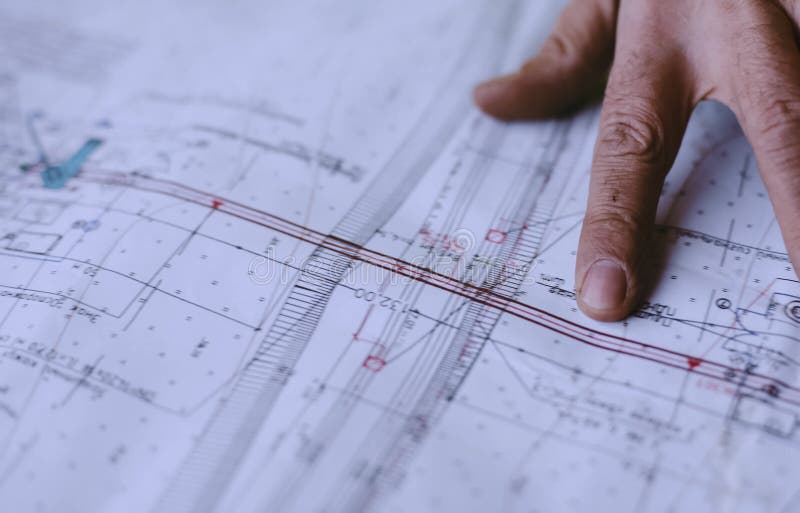 Hands of a Man on a Map Chart. Study of the Scheme of Pipelines Stock ...